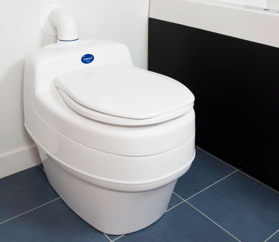 A modern self-contained composting toilet installed in a bright tiny ...